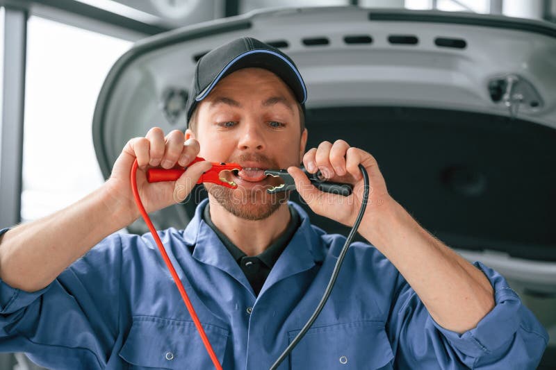 Having Fun with Electrical Terminals, Dangerous. Man in Blue Uniform is ...