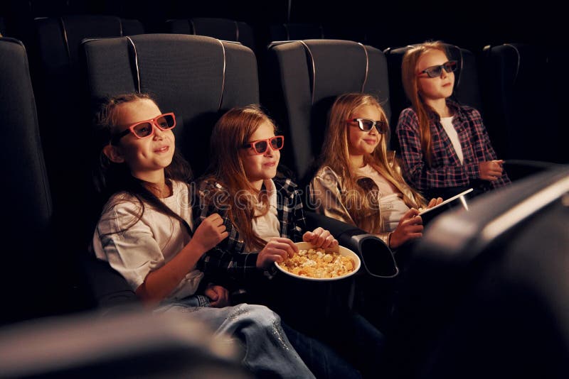 Having Fun. Group of Kids Sitting in Cinema and Watching Movie Together ... Having Fun. Group of Kids Sitting in Cinema and Watching Movie Together ...