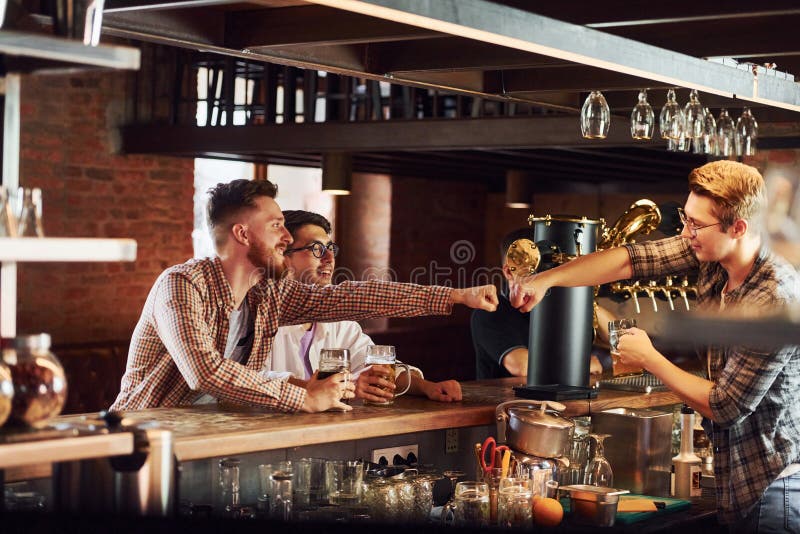 Having Fun. People in Casual Clothes Sitting in the Pub Stock Photo ...