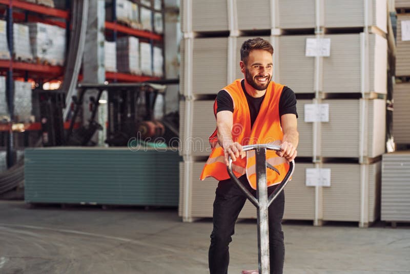 Having Fun by Riding Platform Trolley. Storage Worker is in the ...