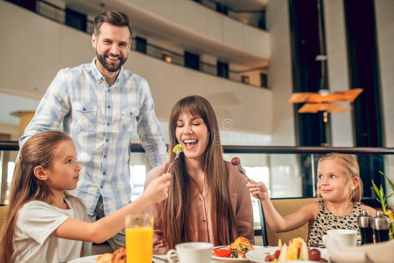 Smiling Family Sitting at the Table and Having Fun Stock Image - Image ...