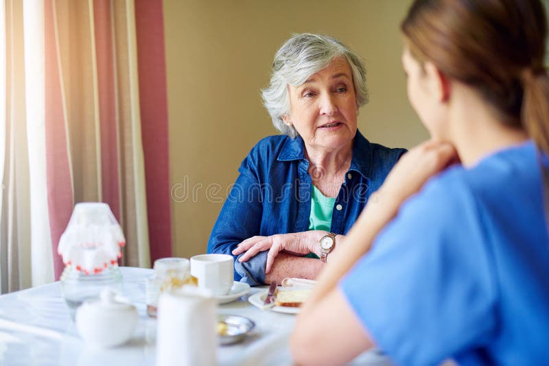 Having a Little Chat Over Breakfast. a Resident and a Nurse at a ...