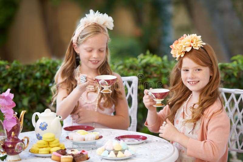Having a Make-believe Tea Party. Two Young Girls Having a Tea Party in ...