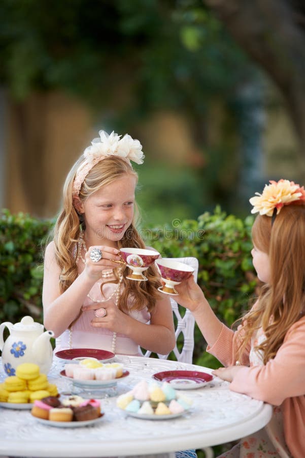 Having a Make-believe Tea Party. Two Young Girls Having a Tea Party in ...