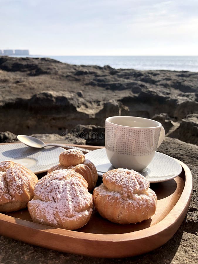 Having Morning Coffee with Eclairs on Beach Stock Photo - Image of ...