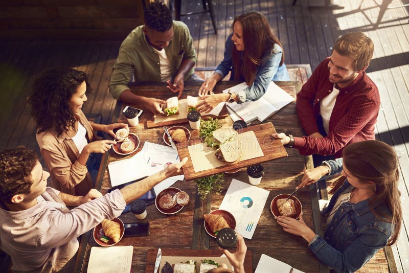 Having a Productive Lunch. High Angle Shot of a Group of Creative ...