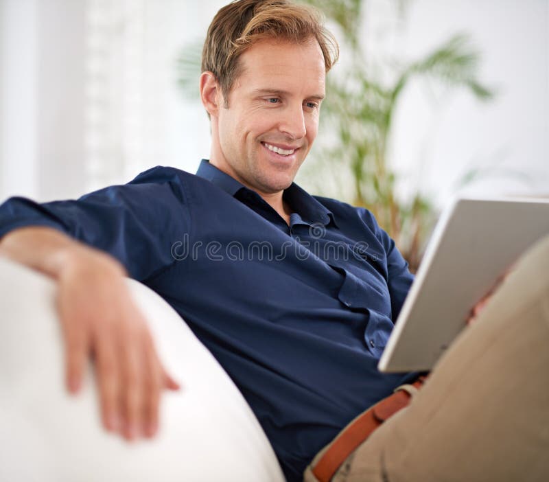 Having a really Relaxed Day...a Handsome Man Using His Tablet while ...