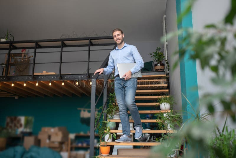 Man Standing on Stairs Holding His Computer Stock Photo - Image of ...