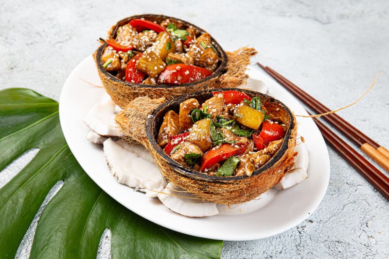 Hawaiian Pinapple Chicken in Natural Coconut Shell Plates on White ...