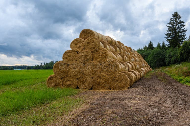Hay Bale Stack before Summer Storm Stock Image - Image of bales, wide ...