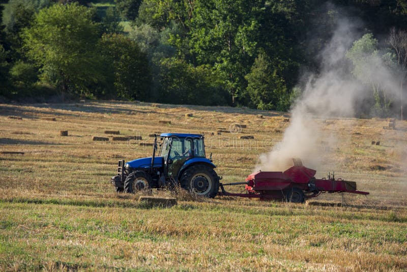 Hay baler in the field stock image. Image of landscape - 131233347