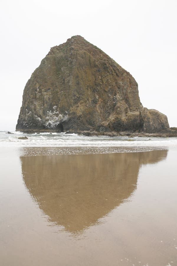 Haystack Rock at Cannon Beach with Mossy Rocks Stock Photo - Image of ...