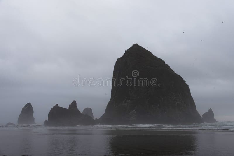 Haystack Rock Cannon Beach stock photo. Image of waves - 312084650