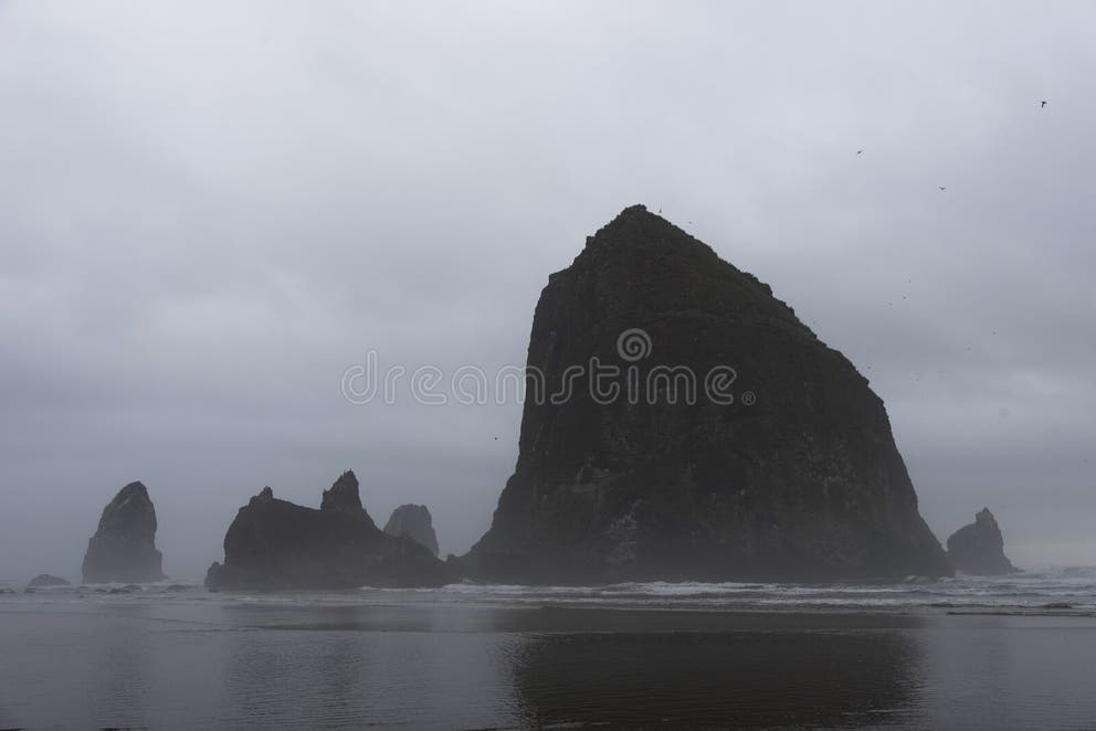 Haystack Rock Cannon Beach stock photo. Image of waves - 312084650