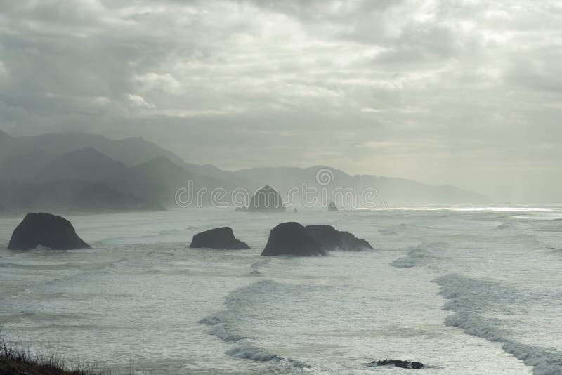 Haystack Rock and Mountains in Mist Stock Image - Image of layers, rock ...