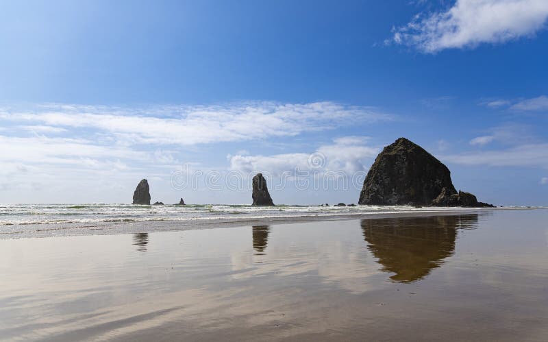 Haystack Rock Rises from the Pacific Ocean at Cannon Beach, Oregon in ...