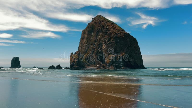 Haystack Rock Rising from Pacific Ocean Near Sandy Beach, Dramatic Rock ...