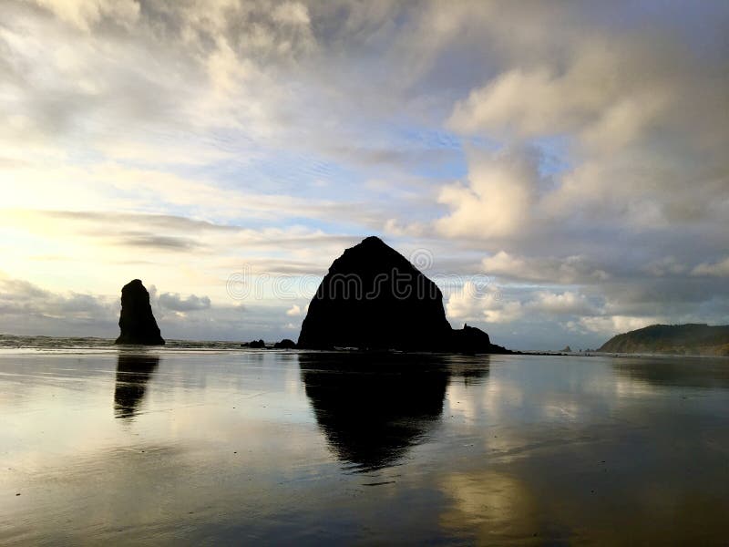 Haystack Rock and Sea Stack Reflections at Cannon Beach Stock Photo ...