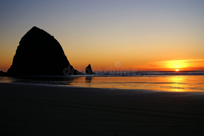 Haystack Rock at Sunset stock image. Image of reflection - 7727785