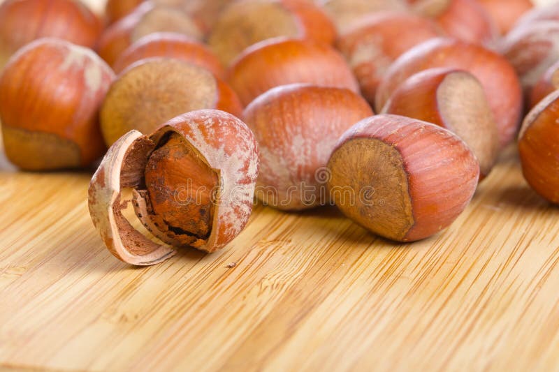 Hazelnut Kernel Inside Shell on Wooden Background Stock Photo - Image ...