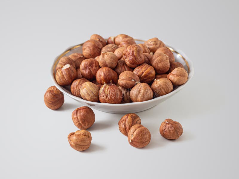 Hazelnuts in a Small Plate on a Light Background Stock Photo - Image of ...