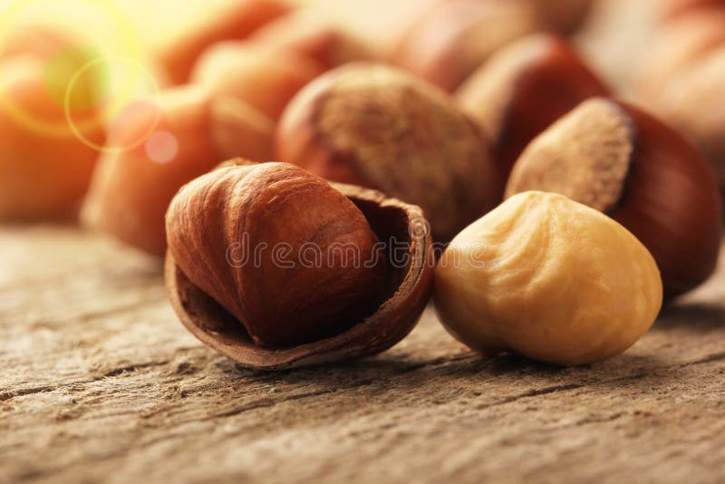 Hazelnuts on wooden table stock photo. Image of abstract - 116173314