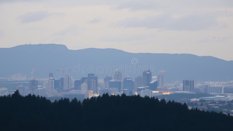 A Hazy Cityscape with a Mountain Range in the Background Stock ...