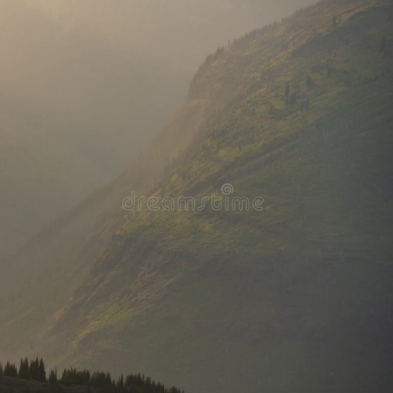 Hazy Light Over Slopes of Mountains in Glacier National Park Stock ...