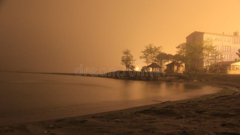 A Hazy Yellow Sky. Sunrise while Morning on the Beach Stock Photo ...