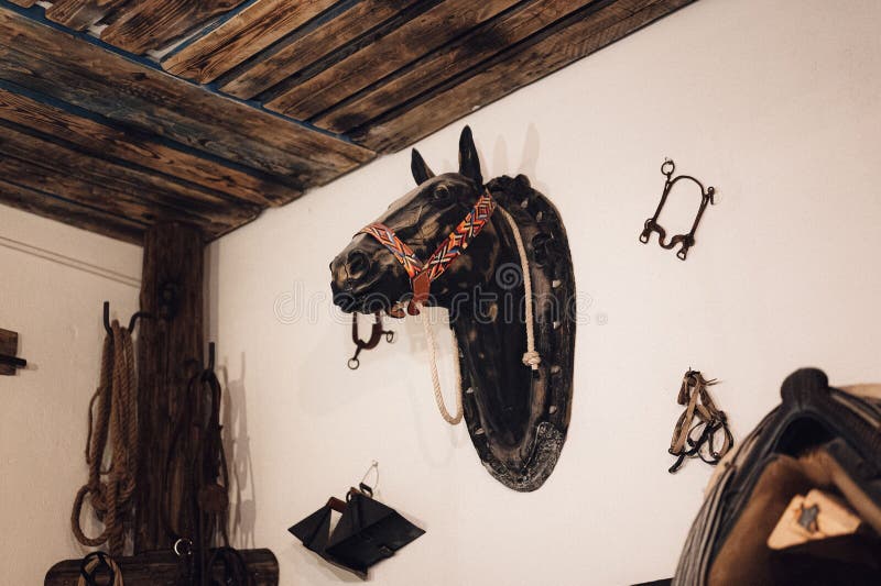 Head of a Black Horse Adorned with Bells and Reins, Hanging on a Wall ...