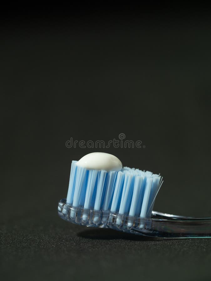Head of a Blue Toothbrush with Toothpaste with Black Background Stock ...