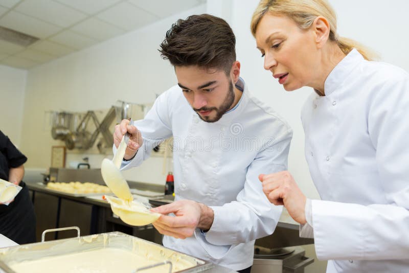 Head Chef with Apprentice in Kitchen Stock Photo - Image of female ...