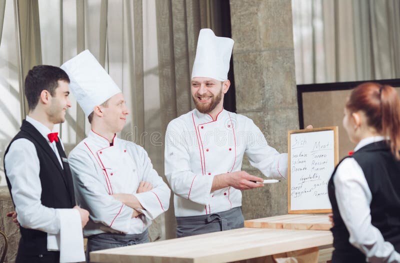 Head Chef and His Staff in Kitchen. Interacting To in Commercial ...