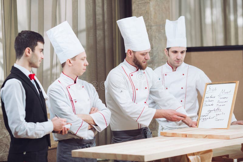 Restaurant Manager and His Staff in Kitchen. Interacting To Head Chef ...