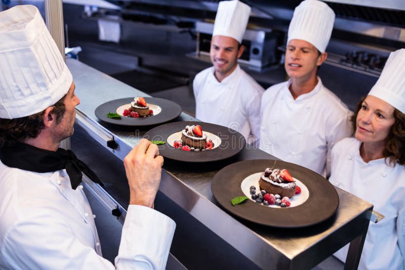 Portrait of Chefs Team Finishing Dessert Plates Stock Image - Image of ...