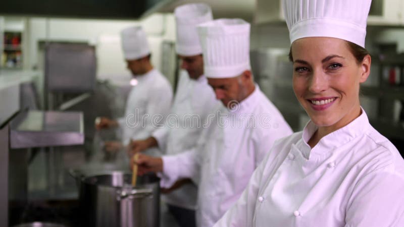 Head Chef Smiling at Camera with Team Behind Her Stock Footage - Video ...