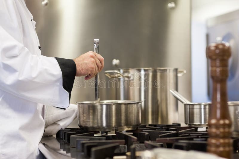 Head chef stirring in pot stock photo. Image of working - 35779956