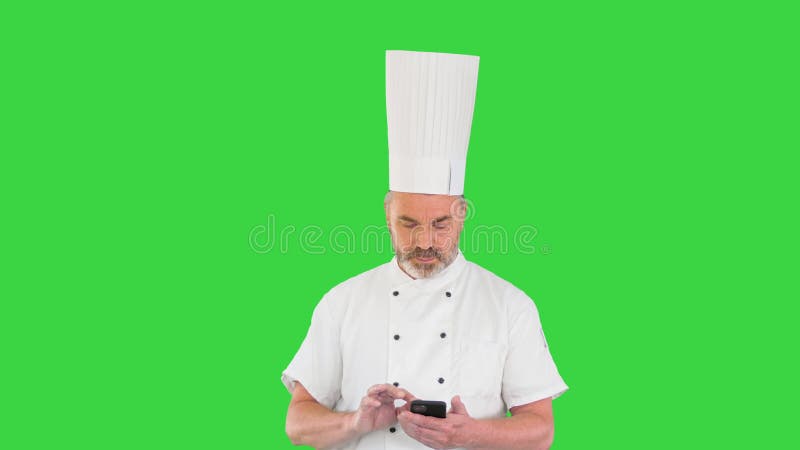 Head Cook Walking and Using Mobile Phone on a Green Screen, Chroma Key ...