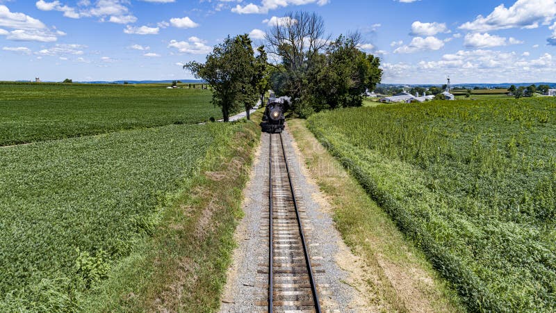 Head on Drone View of a Steam Passenger Train Approaching on a Single ...