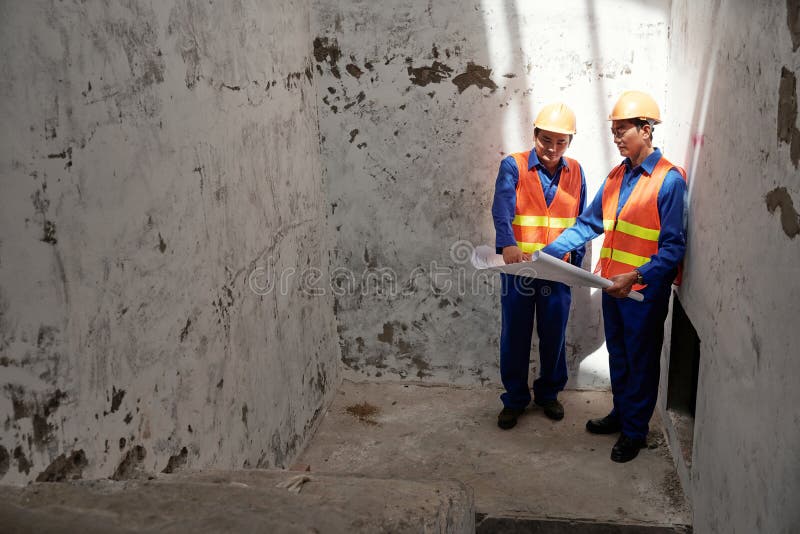 Engineer and Contractor Standing Inside Building Stock Image - Image of ...