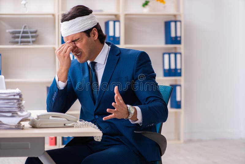 The Head Injured Male Employee Working in the Office Stock Image ...