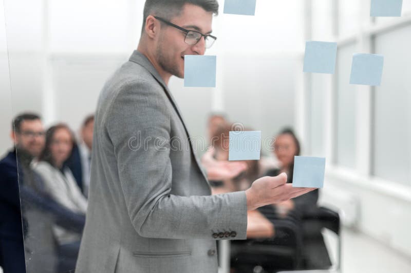 Head of the Project, Pointing To the Sticky Notes during a Work Meeting ...