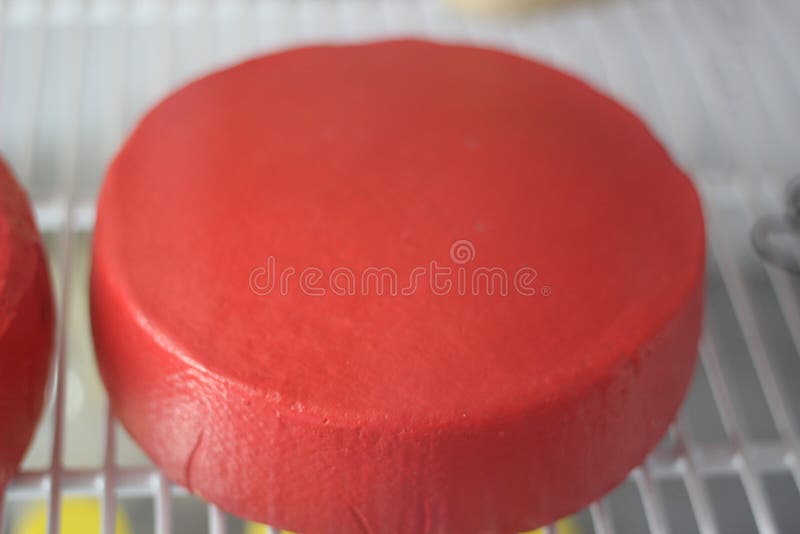 Head of Ripened Hard Cheese Covered with a Red Shell Stock Photo ...