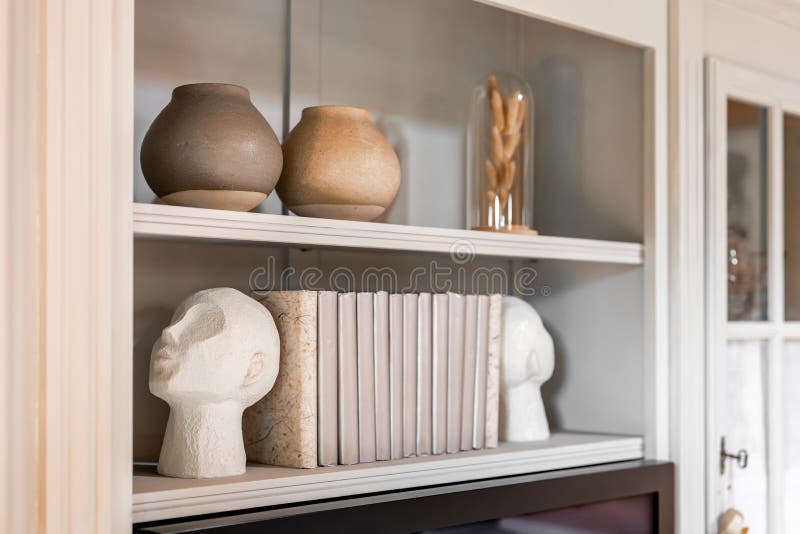 Head Shaped Bookends with Books and Clay Pot on a Shelf Indoors ...