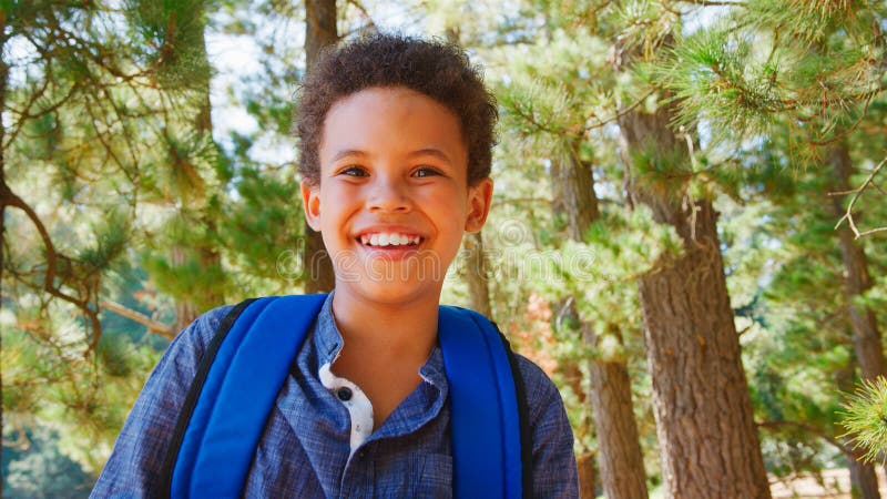 Head and Shoulders Portrait of Boy Wearing Backpack Hiking through ...