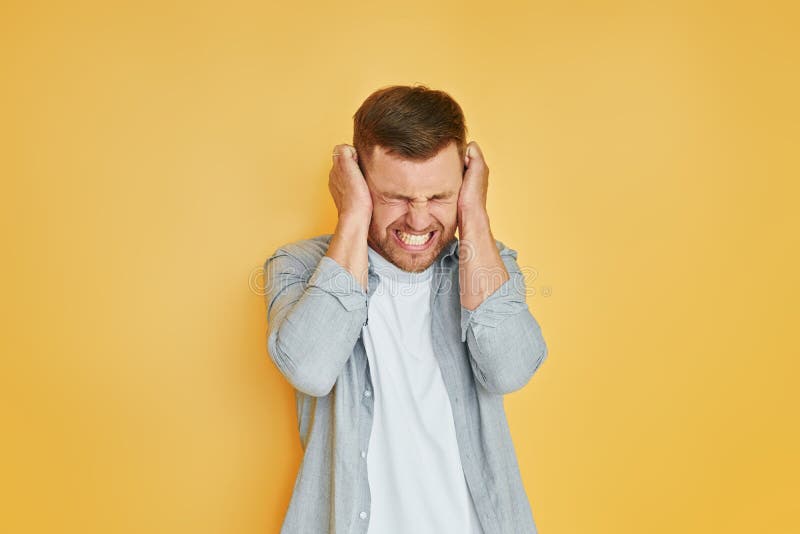 Headache and Anger. Young Man in Casual Clothes Standing Indoors in the ...