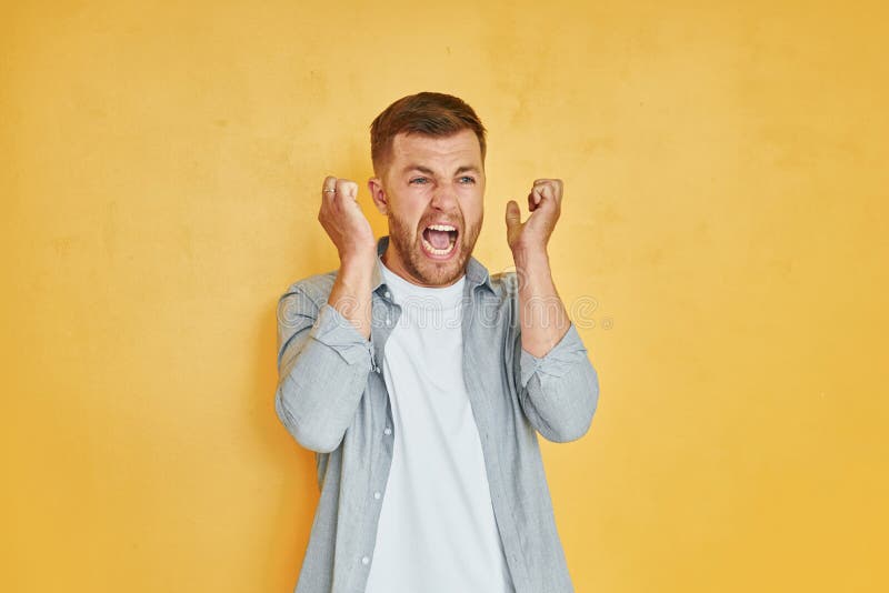Headache and Anger. Young Man in Casual Clothes Standing Indoors in the ...