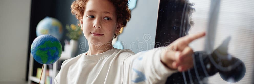 Header Image of Boy Pointing at Solar System Model during Science ...