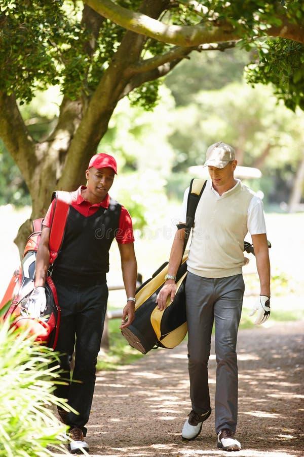Heading Home after a Great Day of Golf. Two Men Walking Down a Shady ...