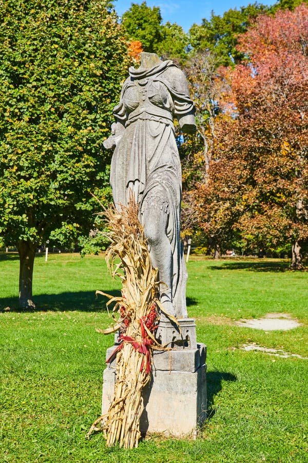 Headless Stone Statue in Fall with Fall Decor in Grass Field Stock ...